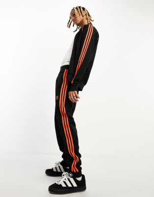 adidas Originals adicolor tracksuit in black and orange | ASOS