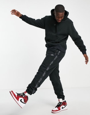 Nike Repeat logo taping polar fleece tracksuit in black | ASOS