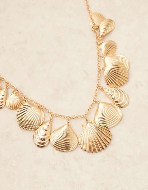 Accessorize Michelle shell charm statement necklace in gold | ASOS