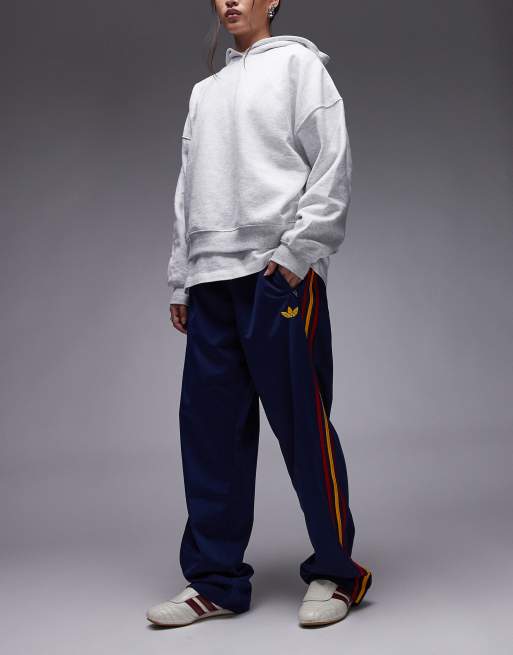 adidas Originals - Firebird - Pantaloni sportivi blu navy e gialli | ASOS