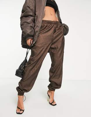 adidas Originals Luxe Lounge repeat logo woven trackies in brown | ASOS