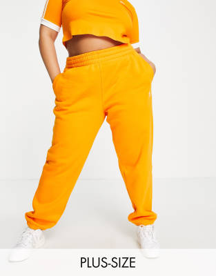 adidas Originals Plus essentials joggers with logo in orange | ASOS