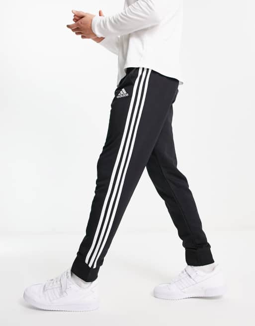 adidas Sportswear Essential 3 stripe trackies in black | ASOS