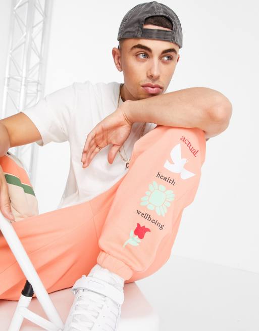 ASOS Actual relaxed trackies with graphic print in orange | ASOS
