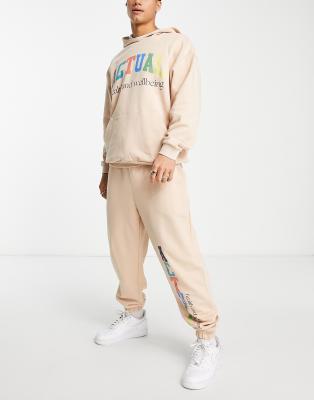 ASOS Actual relaxed trackies with multi coloured logo print in beige (part of a set) | ASOS