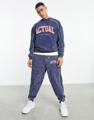 ASOS Actual relaxed trackies with piping and front print logo in washed ...