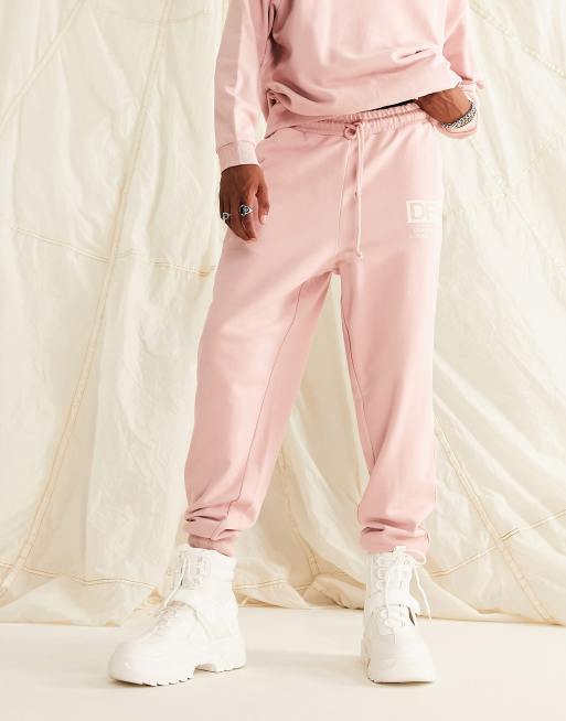 ASOS Dark Future relaxed trackies with front and back logo prints in ...