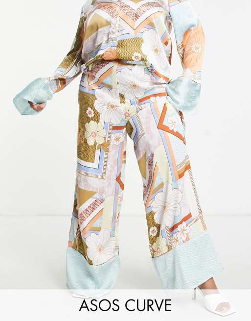 ASOS DESIGN Curve - Pantalon d'ensemble en satin à imprimé fleuri rétro placé | ASOS