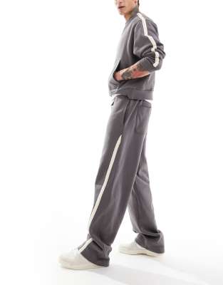 ASOS DESIGN extreme wide leg trackies with slanted side tape with text print in charcoal | ASOS