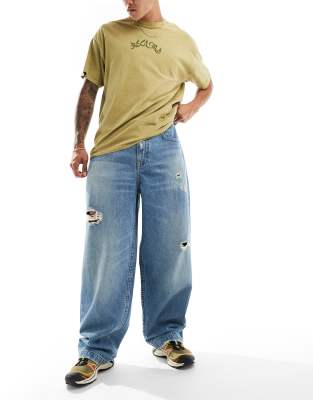 ASOS DESIGN loose fit jeans with rips in light wash blue | ASOS