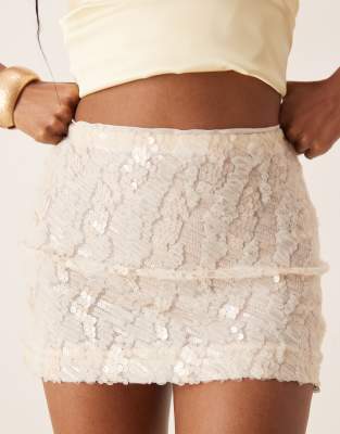 ASOS DESIGN - Mini-jupe en tulle semi-transparent à sequins et volants - Ivoire | ASOS