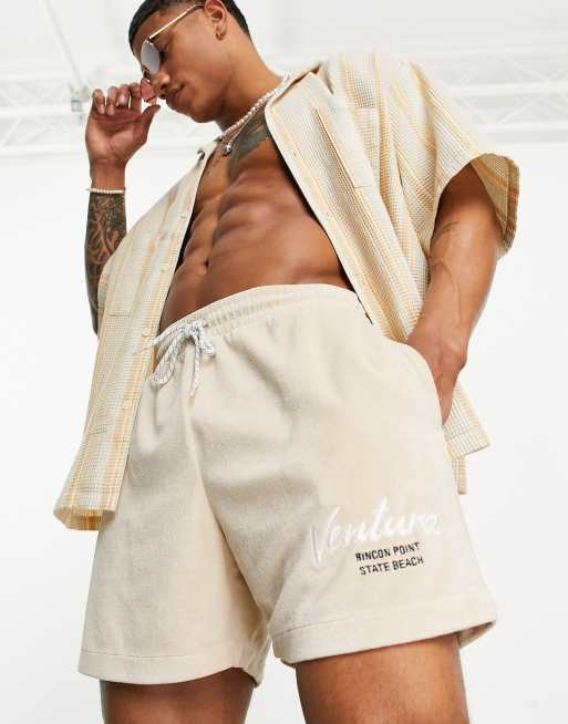 ASOS DESIGN oversized shorts in beige towelling with text embroidery | ASOS