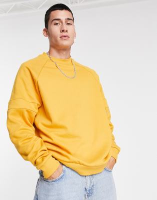 ASOS DESIGN oversized sweatshirt with sleeve seam details in yellow ...
