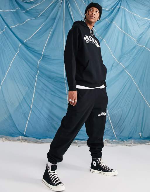 Asos Design Oversized Trackies In Black With Text Print Part Of A Set