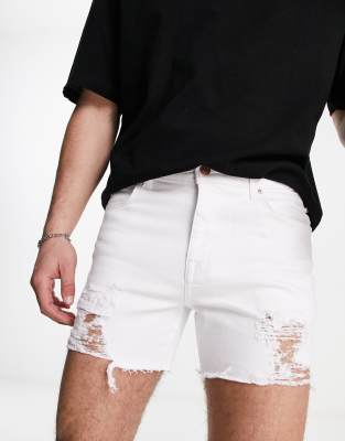 ASOS DESIGN shorter length denim shorts with rips in white | ASOS