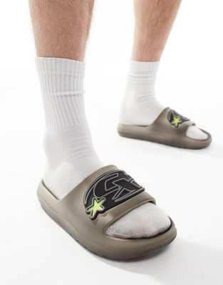 ASOS DESIGN slides in stone with distressed spray print and badge | ASOS