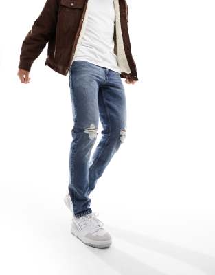 ASOS DESIGN slim jeans in vintage mid blue with rips | ASOS