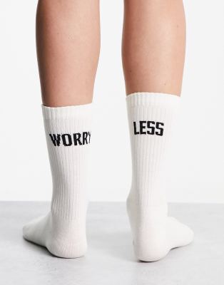 ASOS DESIGN socks with worry less slogan in off white | ASOS