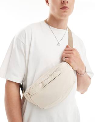 ASOS DESIGN soft cross body bum bag with multiple compartments in ecru ...