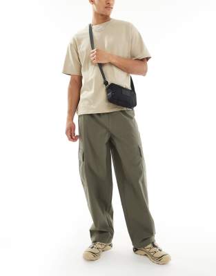 ASOS DESIGN super baggy cargo pants with elasticated waist in washed ...