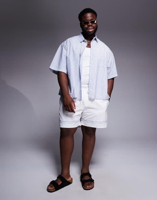 ASOS DESIGN swim shorts in mid length in stone with border print | ASOS