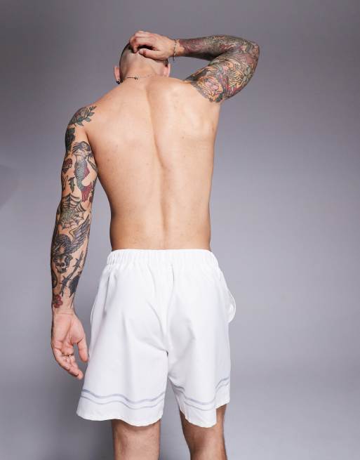 ASOS DESIGN swim shorts in mid length in stone with border print | ASOS