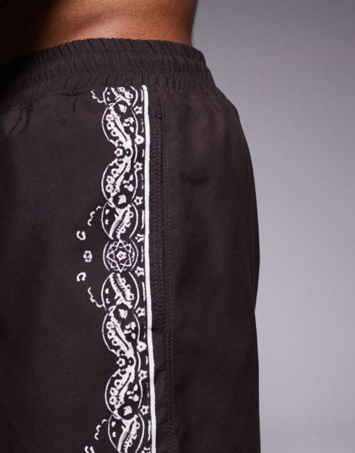 ASOS DESIGN swim shorts in mid length with border print in brown | ASOS