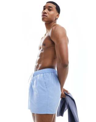 ASOS DESIGN swim shorts in short length with pocket detail in light ...