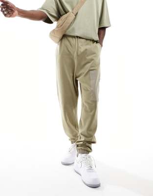 ASOS DESIGN tapered trackies with nylon pocket in beige | ASOS