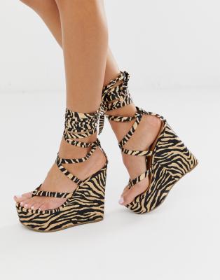 ASOS DESIGN Tribute thong tie leg wedges in tiger | ASOS