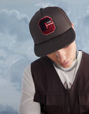 ASOS DESIGN trucker cap with textured letter badge in brown | ASOS