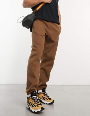 Carhartt WIP Chase trackies in brown | ASOS