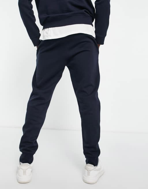 Champion large logo trackies in navy | ASOS