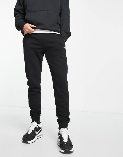 Champion logo trackies in black | ASOS