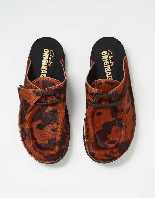 Clarks Originals Desert Nomad mules in brown cow print | ASOS