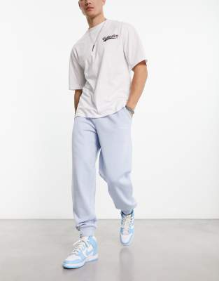 COLLUSION logo trackies in light blue | ASOS