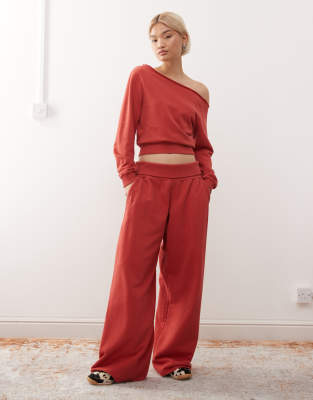 COLLUSION low rise trackies with fold over waistband in washed red ...