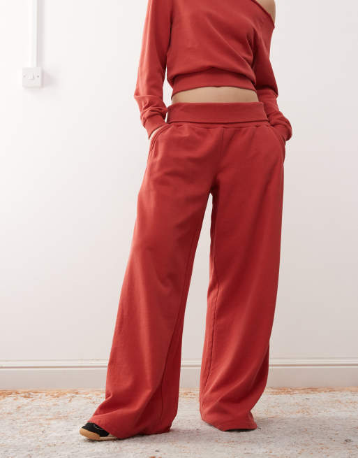 COLLUSION low rise trackies with fold over waistband in washed red ...