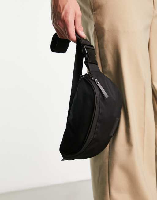 Consigned logo bum bag in black | ASOS