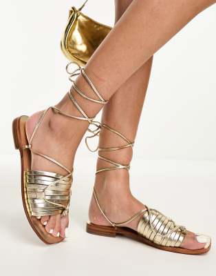 Free People strap detail flat sandals in gold | ASOS