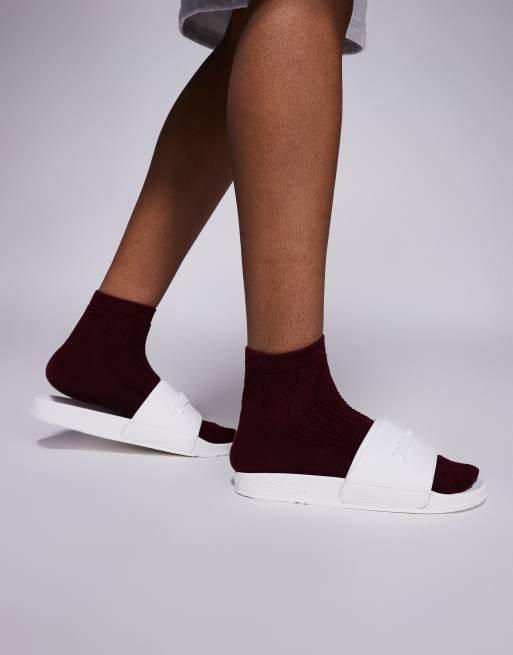 Juicy Couture Breanna embossed sliders with DTM logo in white | ASOS