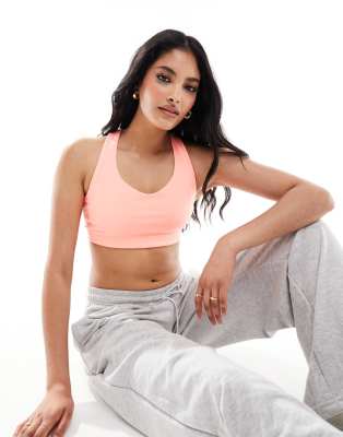 New Balance Nb fuel sports bra in coral | ASOS