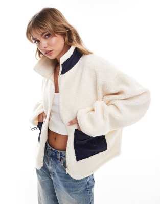 Polar color crema y azul marino de borreguito con cremallera y ...