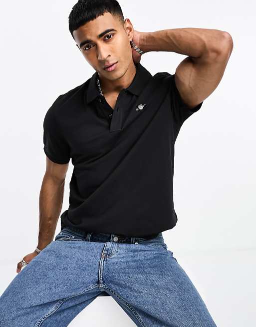 Polo negro de corte estándar con logo de escudo de piqué de GANT | ASOS Polo negro de corte estándar con logo de escudo de piqué de GANT | ASOS