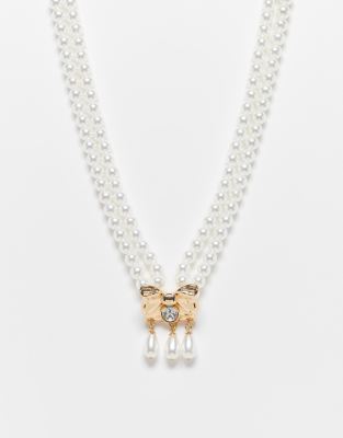 Reclaimed Vintage pearl necklace with bow drop in gold | ASOS