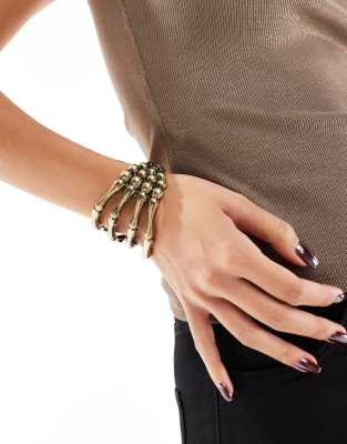 Reclaimed Vintage unisex Halloween skull bangle in gold | ASOS