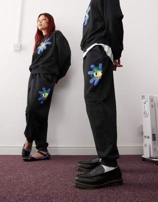 Reclaimed Vintage unisex sweatpants with flower print in washed black ...