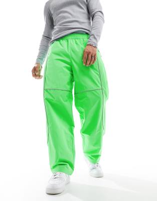 The North Face Tek woven trackies with reflective piping in bright ...