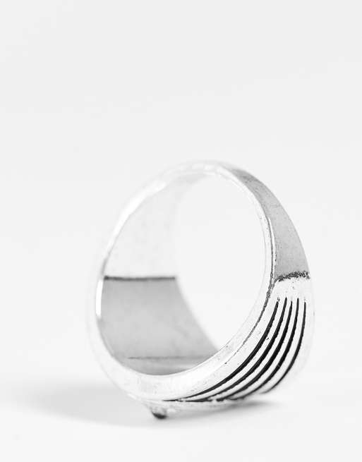 The Status Syndicate oval signet ring with moon and star detail in ...