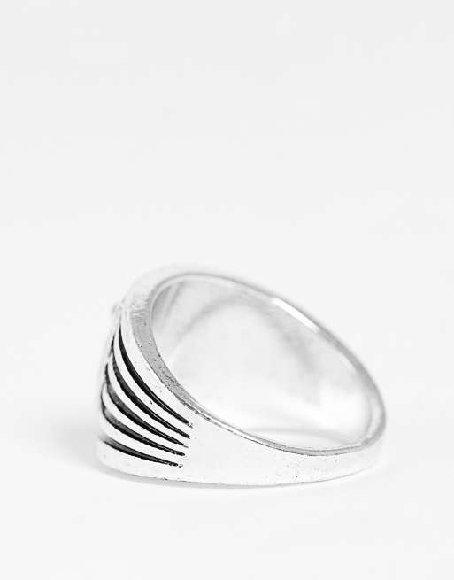 The Status Syndicate oval signet ring with moon and star detail in ...